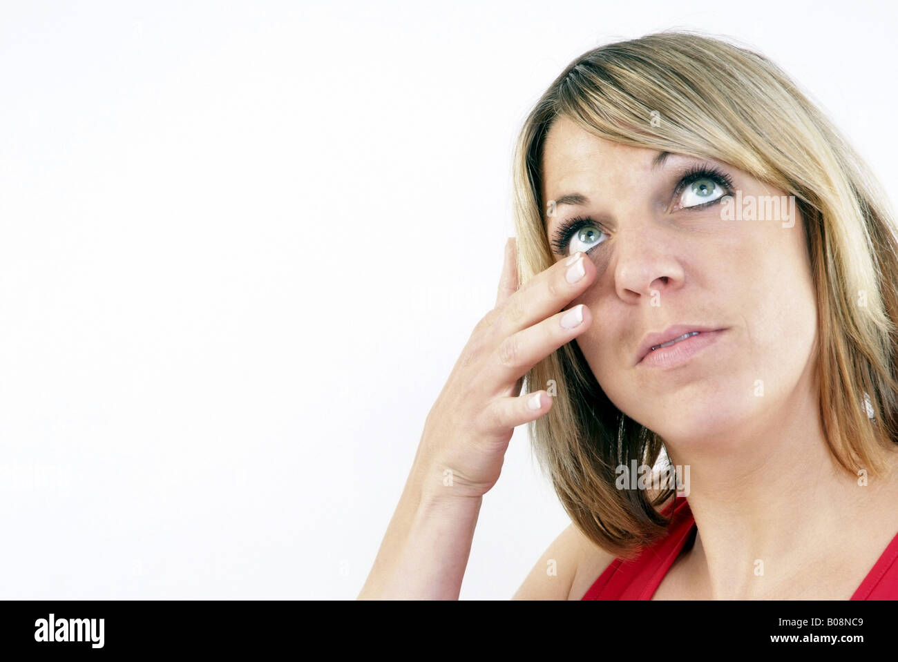blond woman with aching eyes Stock Photo - Alamy