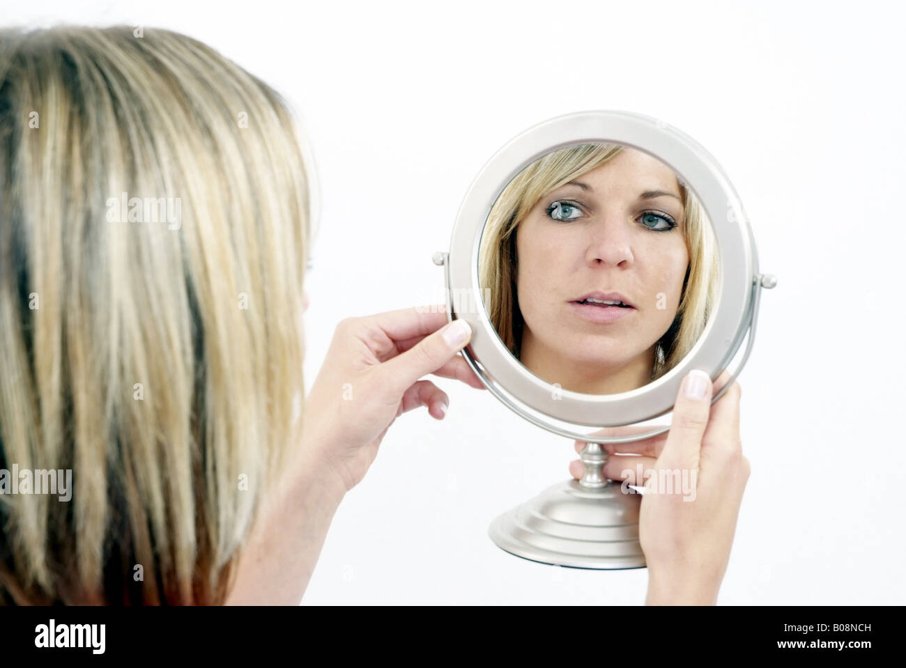 fair-haired woman with makeup mirror Stock Photo - Alamy