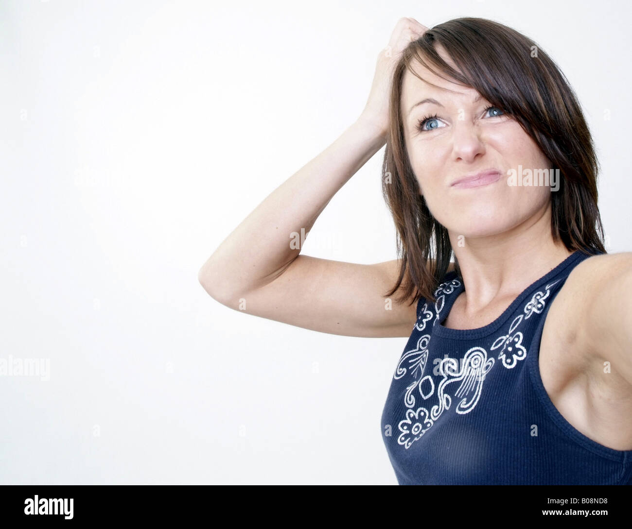 sceptical woman scatching her head Stock Photo - Alamy