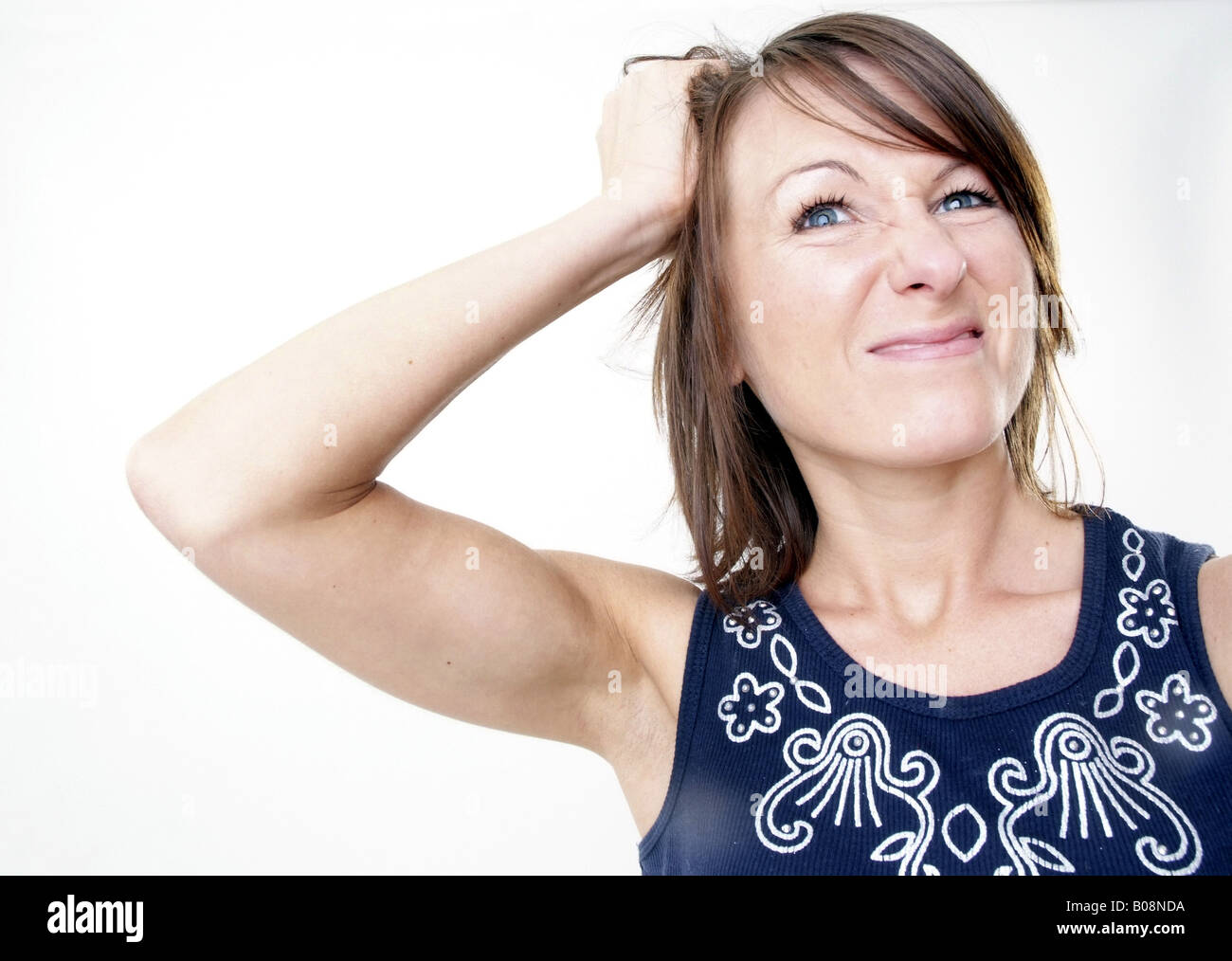 sceptical woman scatching her head Stock Photo - Alamy