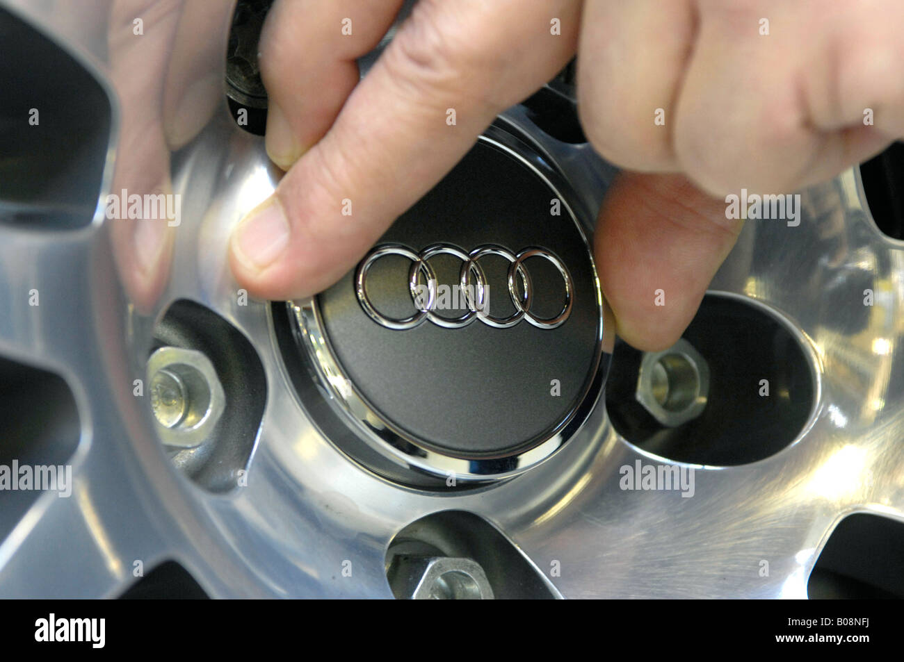 Setting an AUDI logo in the wheel rim during final assembly of an Audi ...