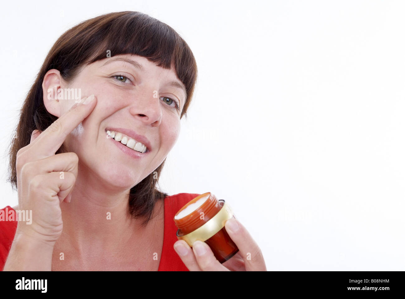 Woman putting on eye cream hi-res stock photography and images - Alamy
