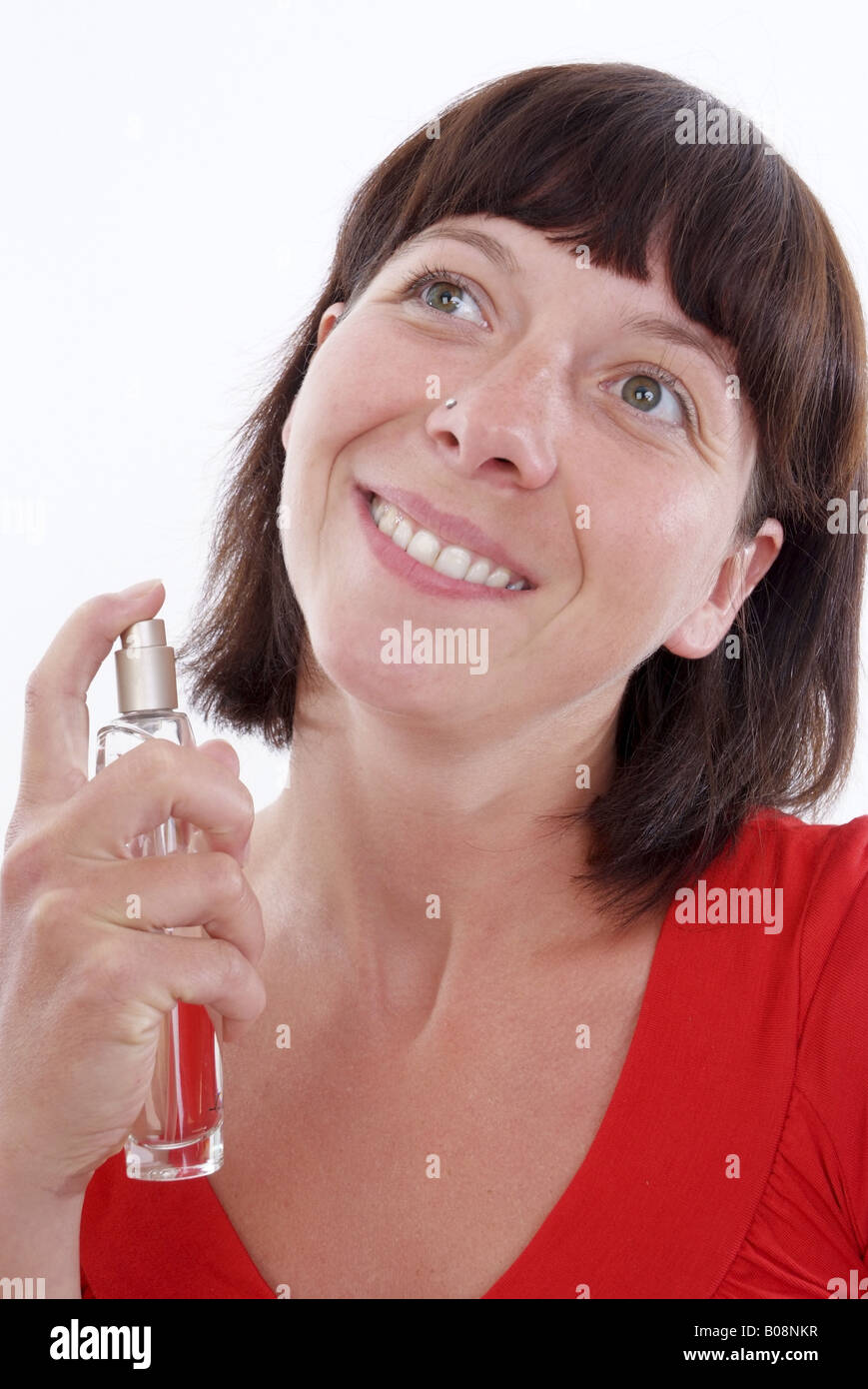 Woman spraying perfume from hi-res stock photography and images - Alamy