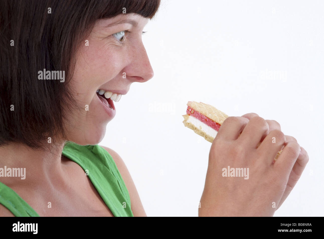 brown-haired woman with cream slice, ravenous appetite Stock Photo - Alamy