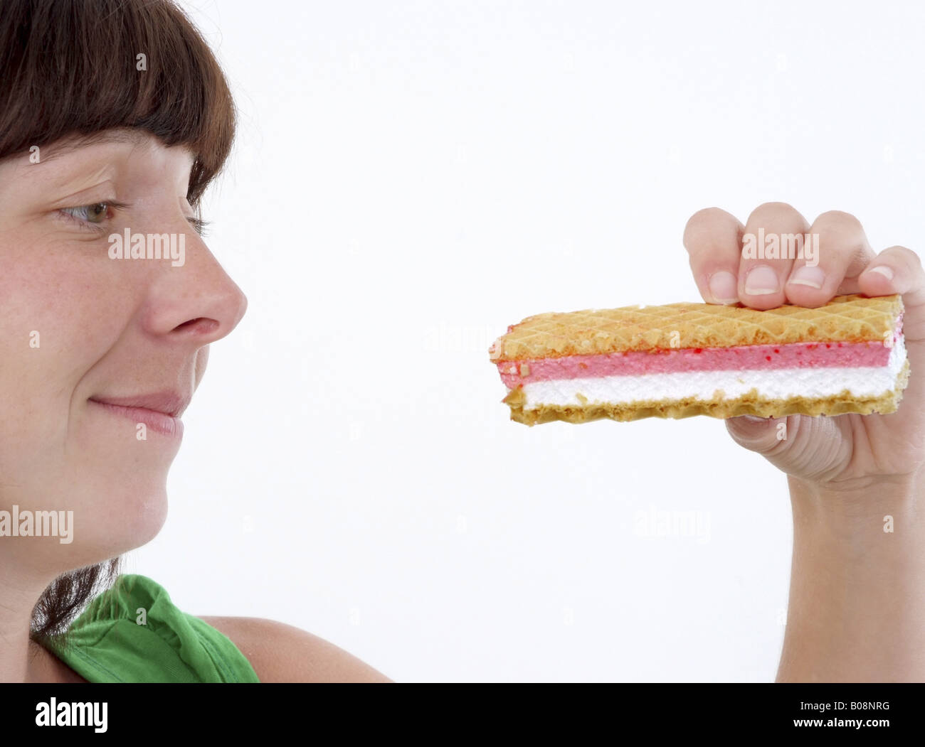 brown-haired woman with cream slice, ravenous appetite Stock Photo - Alamy