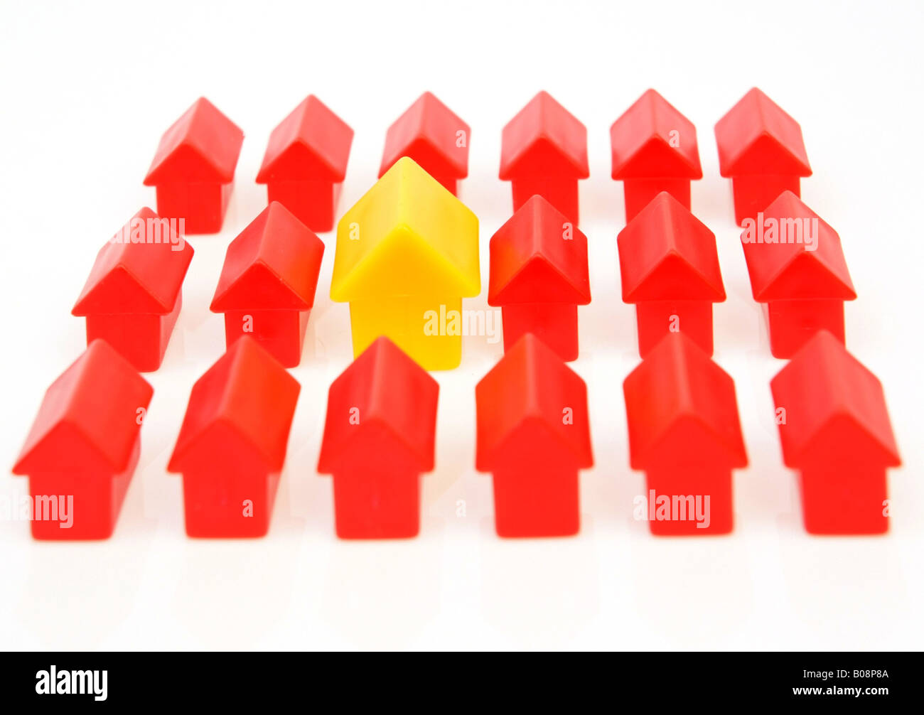yellow house amidst rows of red houses Stock Photo - Alamy