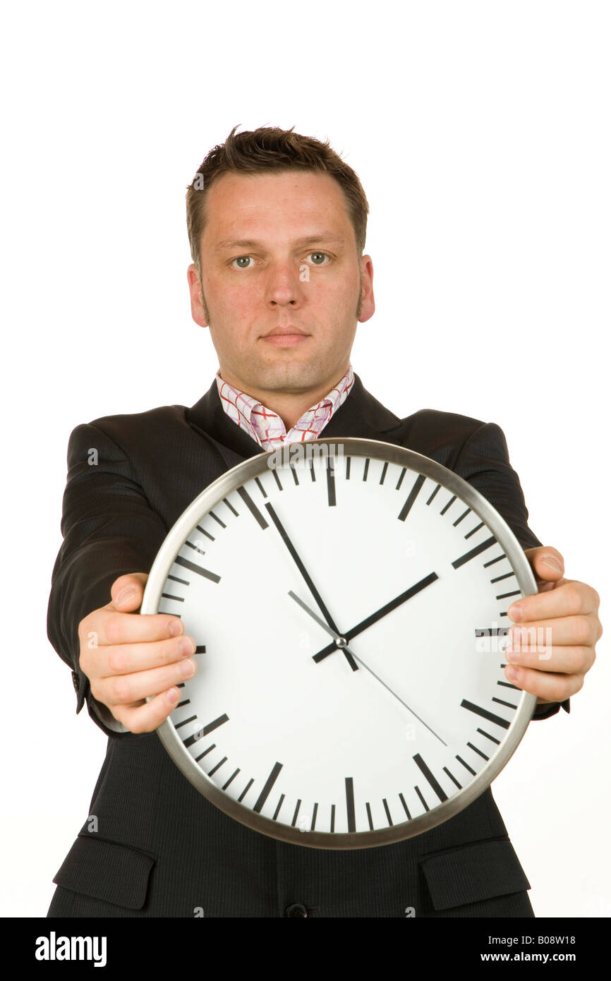 40 year-old businessman holding a clock Stock Photo - Alamy