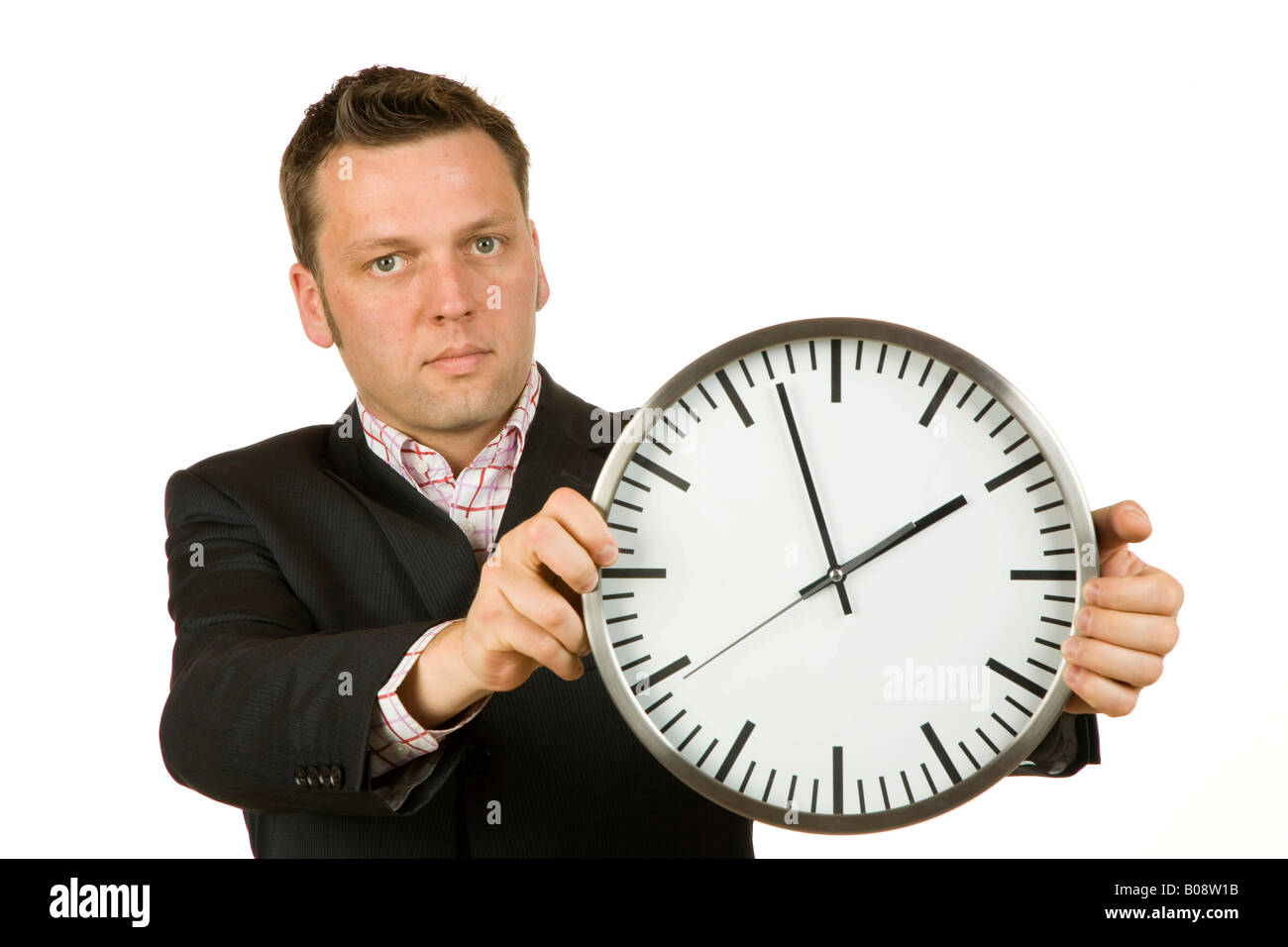 40 year-old businessman holding a clock Stock Photo - Alamy