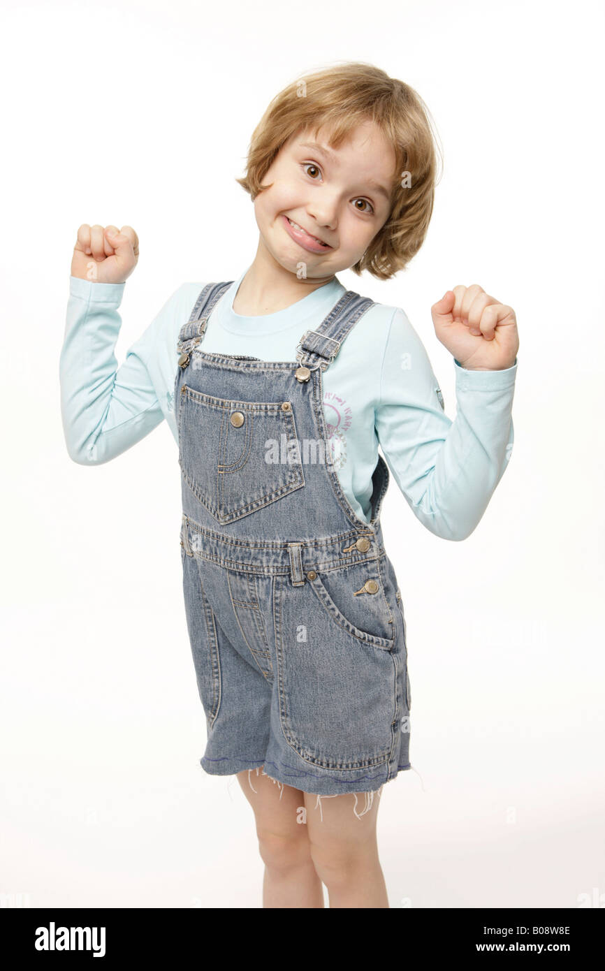 Dark-blonde, 8-year-old girl acting goofy, winner's pose Stock Photo ...
