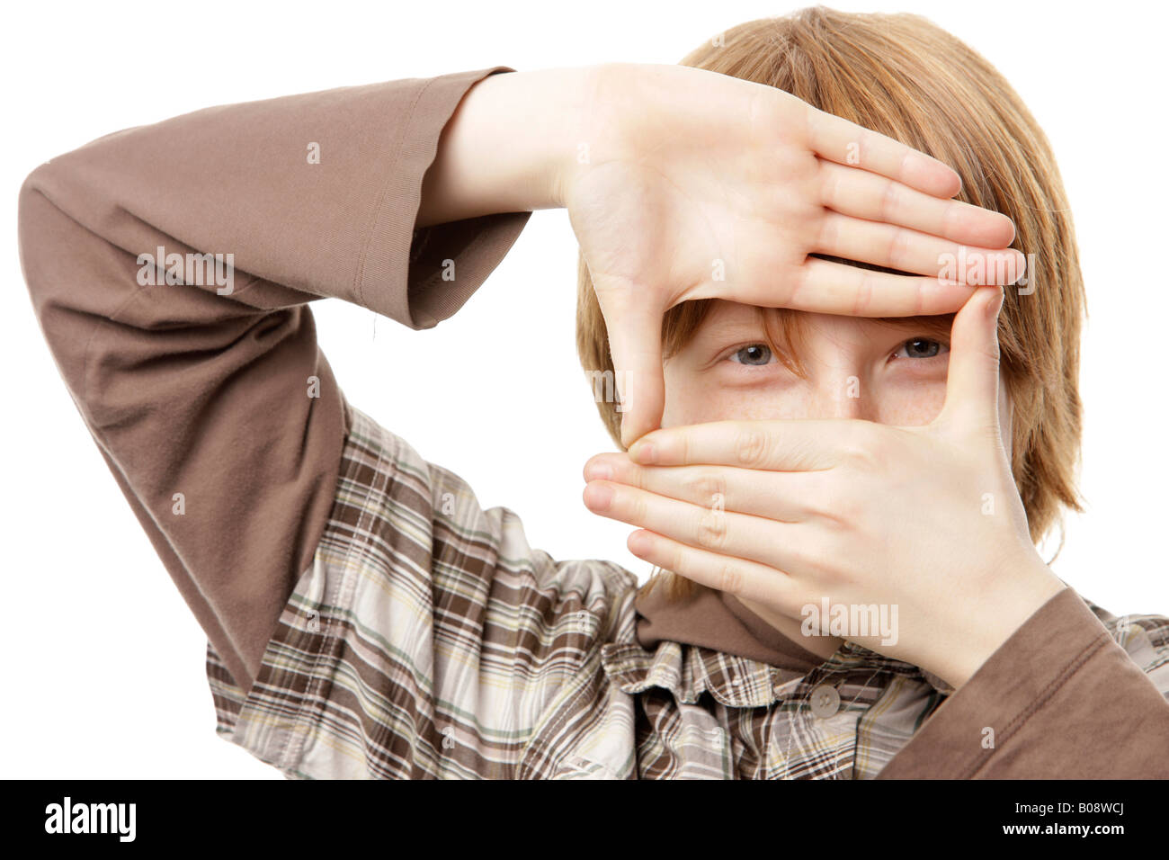 12-year-old boy holding his hands in front of his face Stock Photo - Alamy