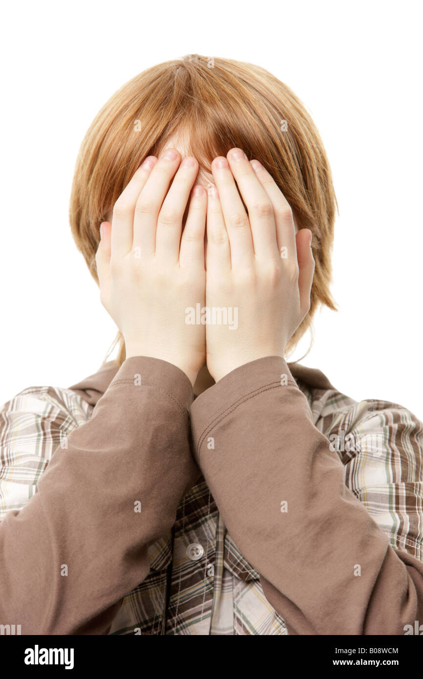 12 year old boy covering face hands hi-res stock photography and images ...