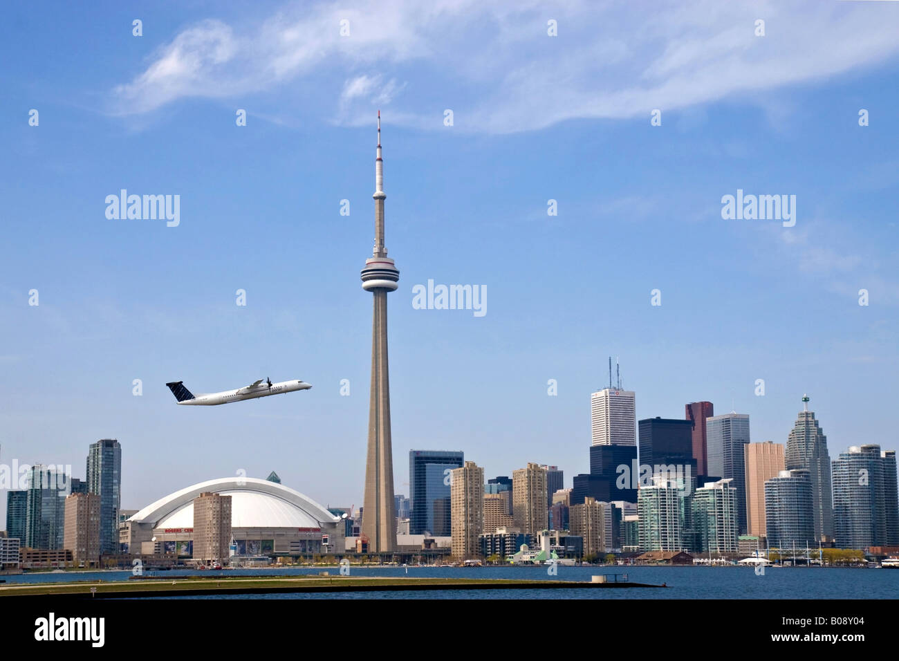 The Toronto skyline with a propeller airplane flying past Stock Photo ...