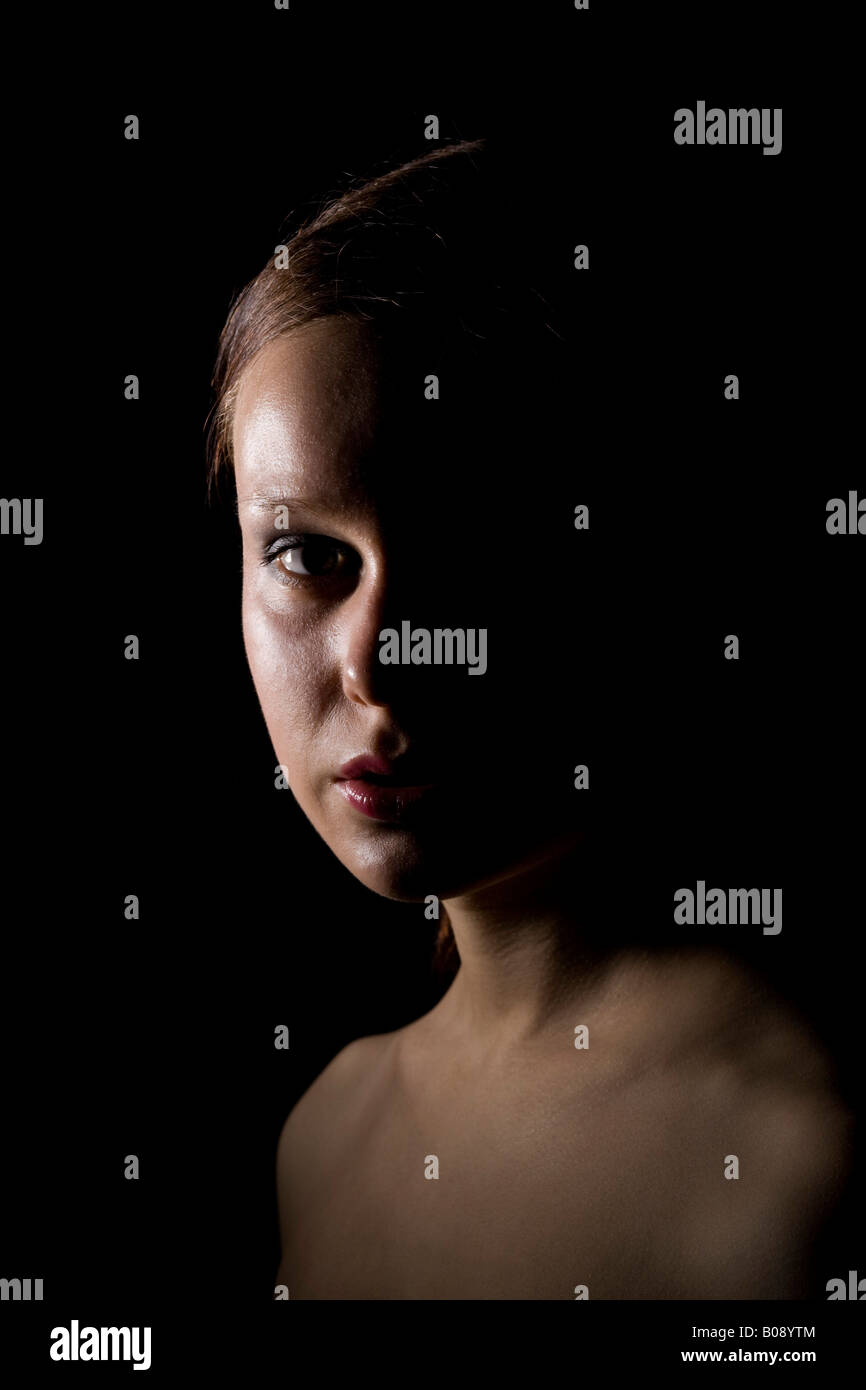 Portrait of a young woman, strong side lighting, shadow Stock Photo - Alamy