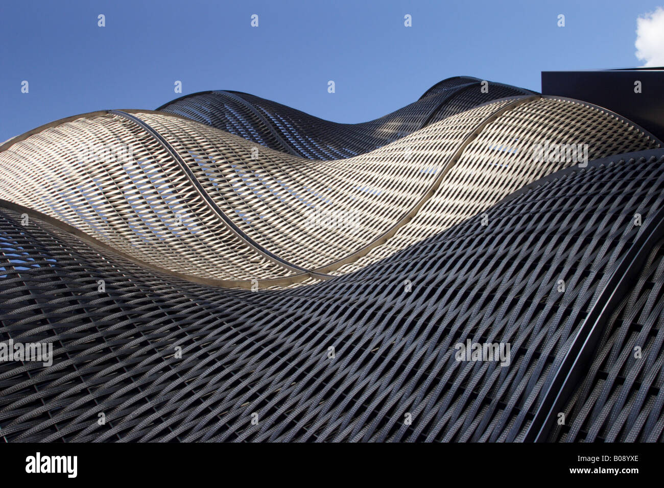 Evening sunlight making waves on an architectural facade made of steel ...