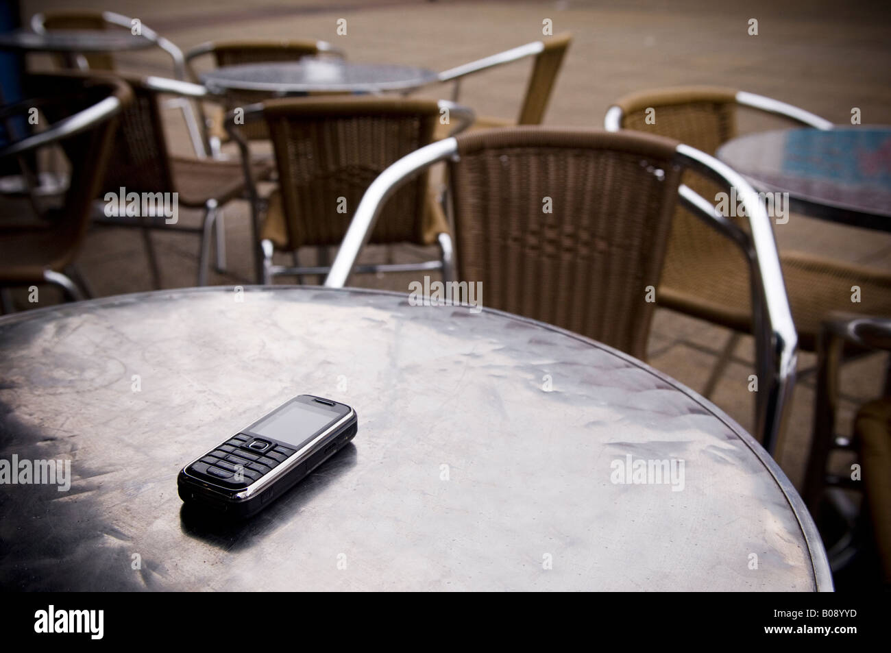 Mobile cellphone left behind on restaurant table outdoors Stock Photo ...