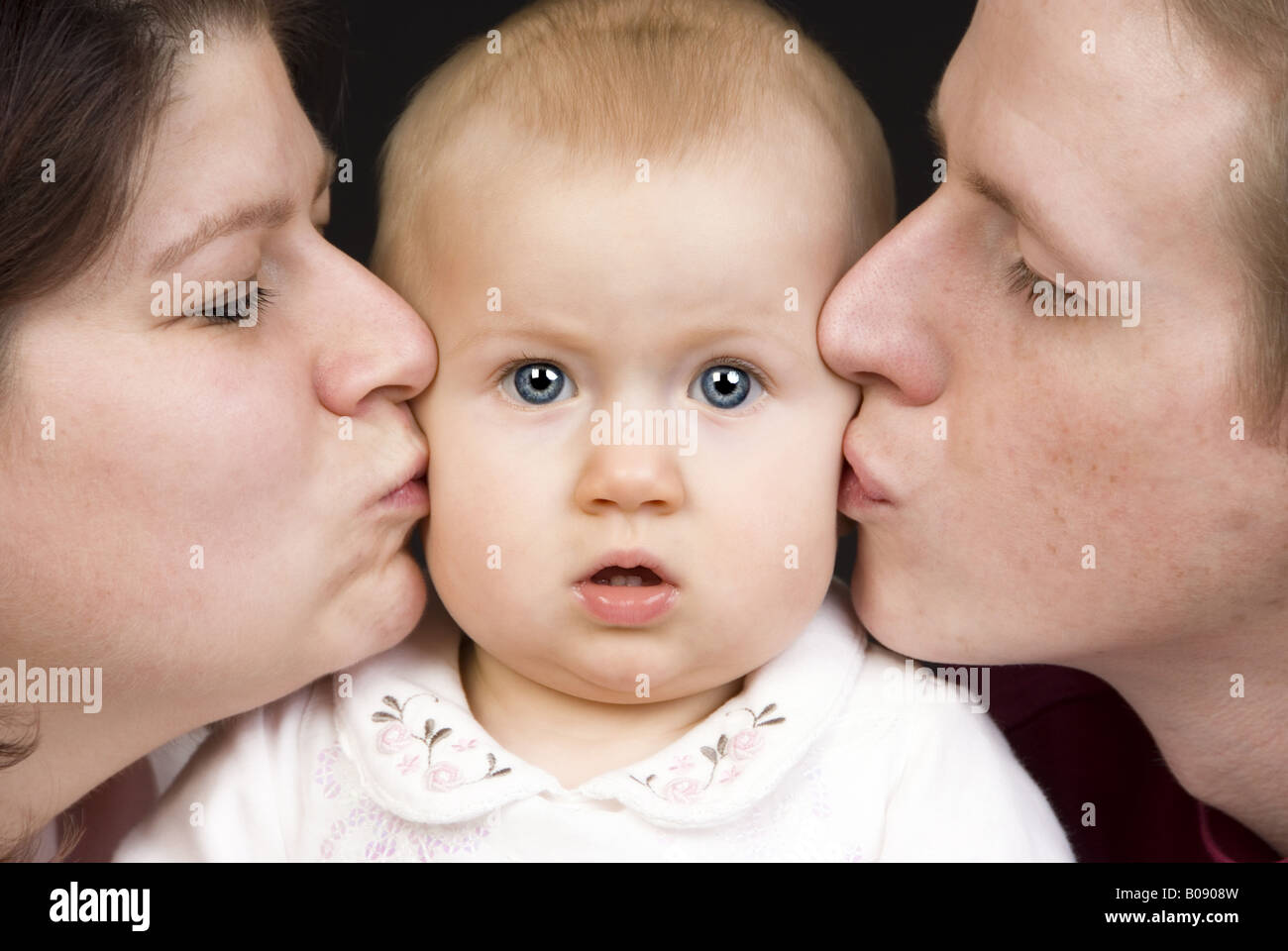 Parents kissing child lips hi-res stock photography and images - Alamy