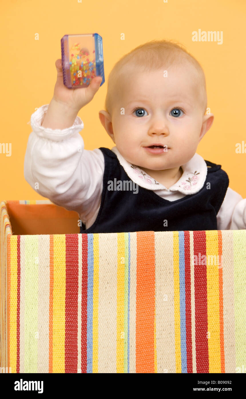 baby with rattle in a box Stock Photo - Alamy