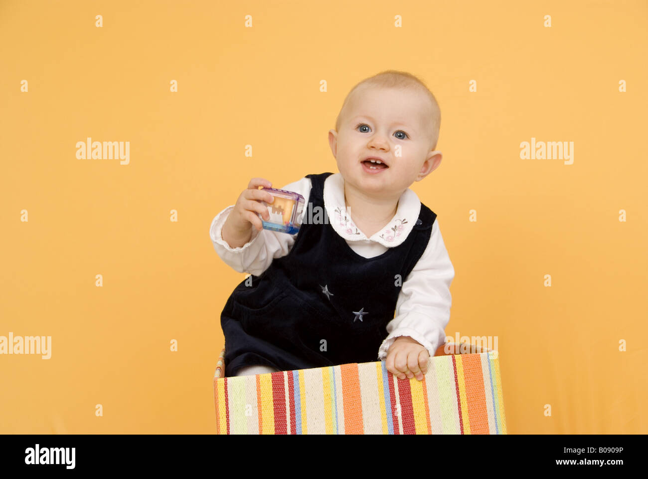 Baby girl standing in box hi-res stock photography and images - Alamy