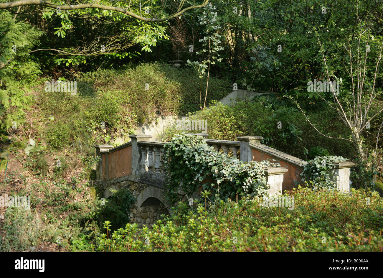 Overgrown romantic bridge Stock Photo - Alamy