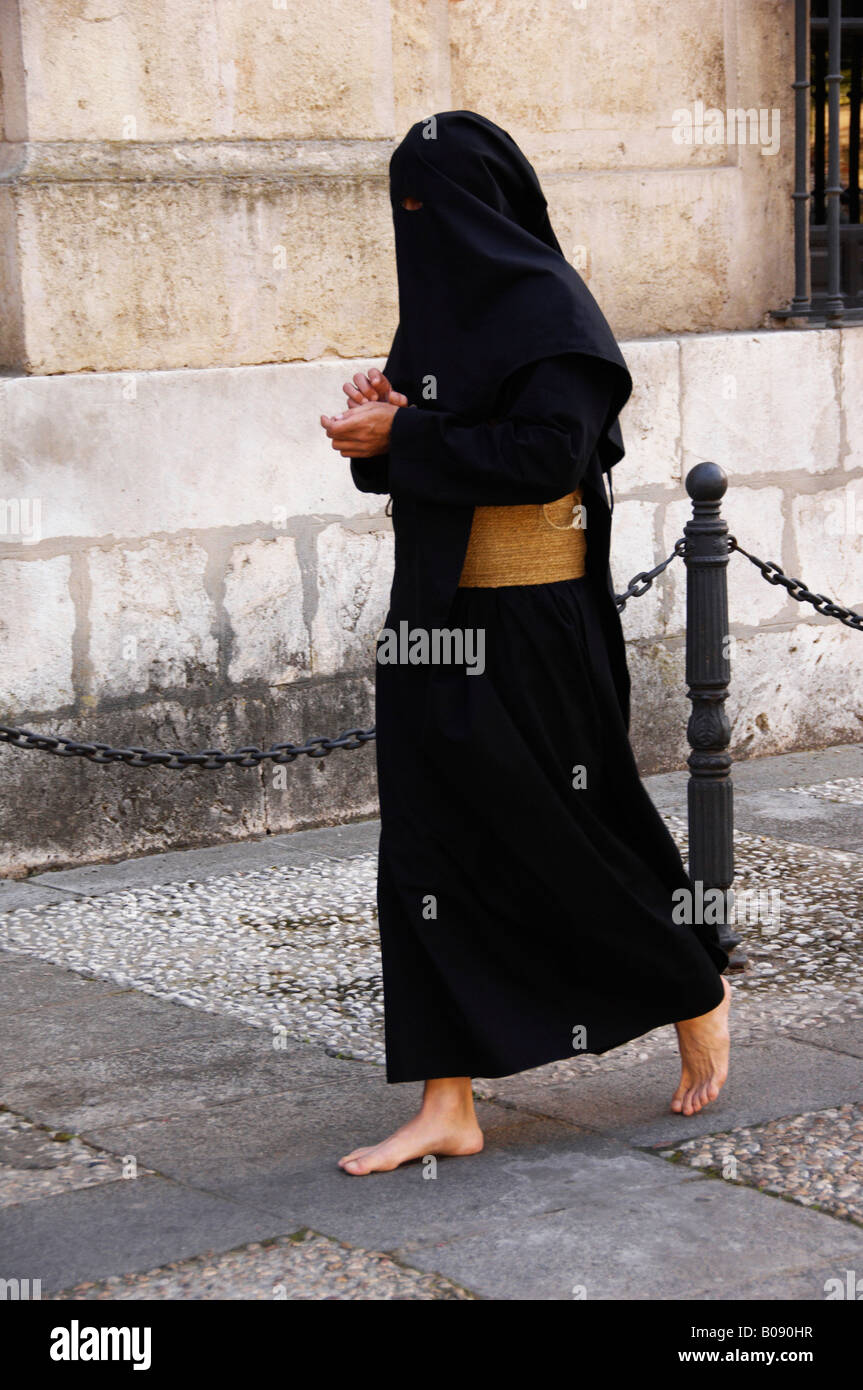 Penitent dressed in black penitential robe (nazareno) on their way to ...