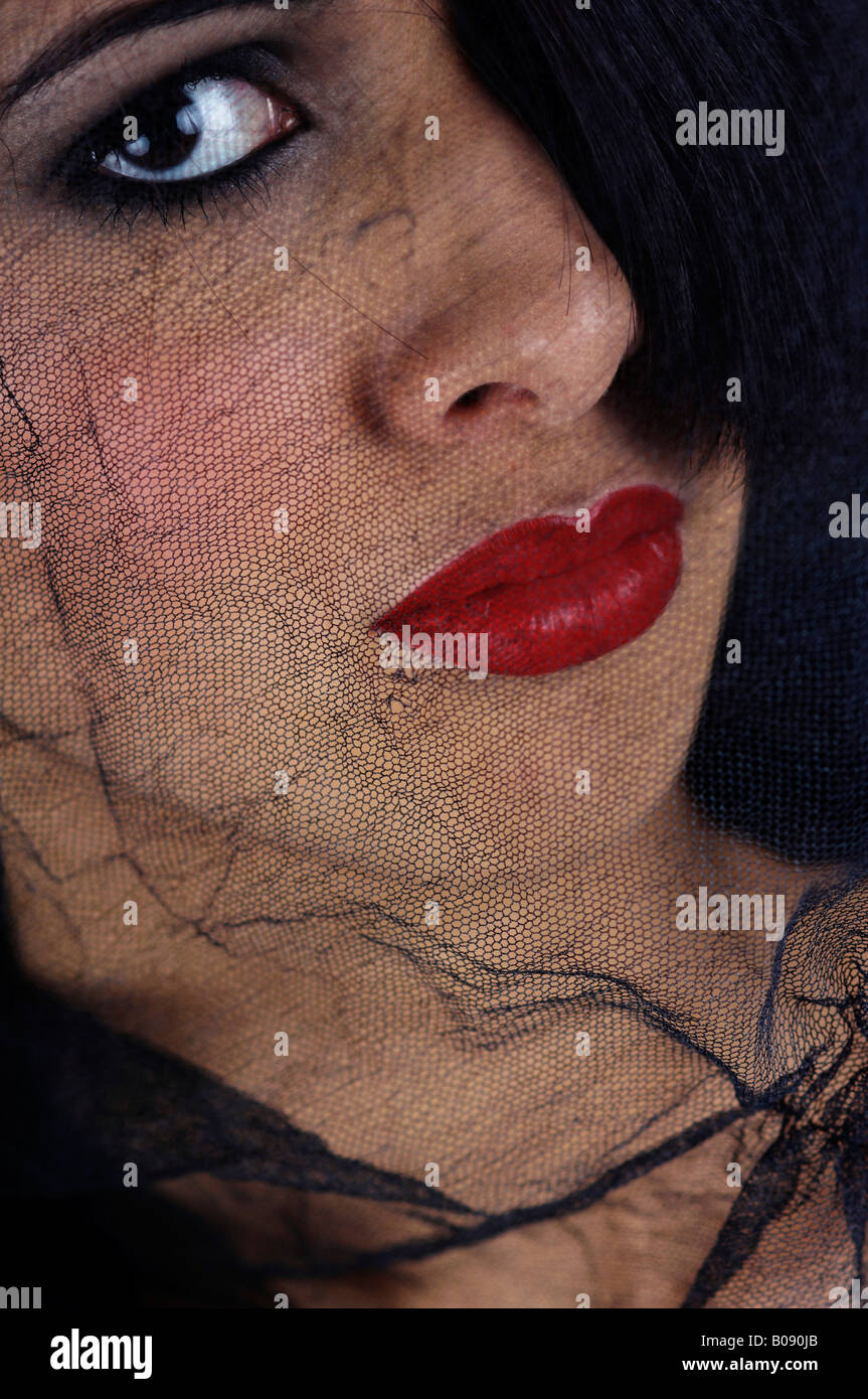 Netted black veil covering a young woman's face, widow Stock Photo - Alamy