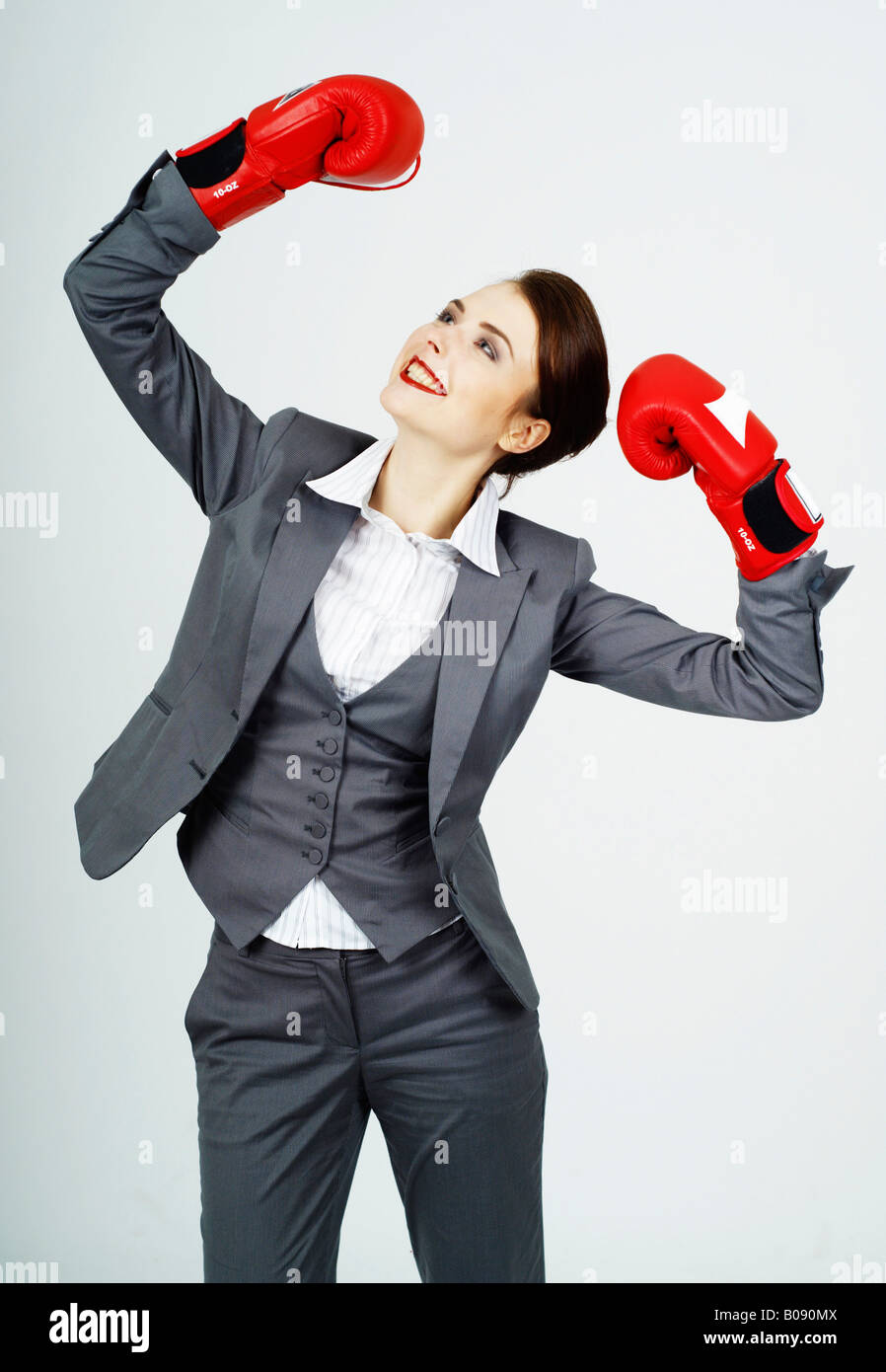Businesswoman wearing boxing gloves, winner's pose, victory Stock Photo ...