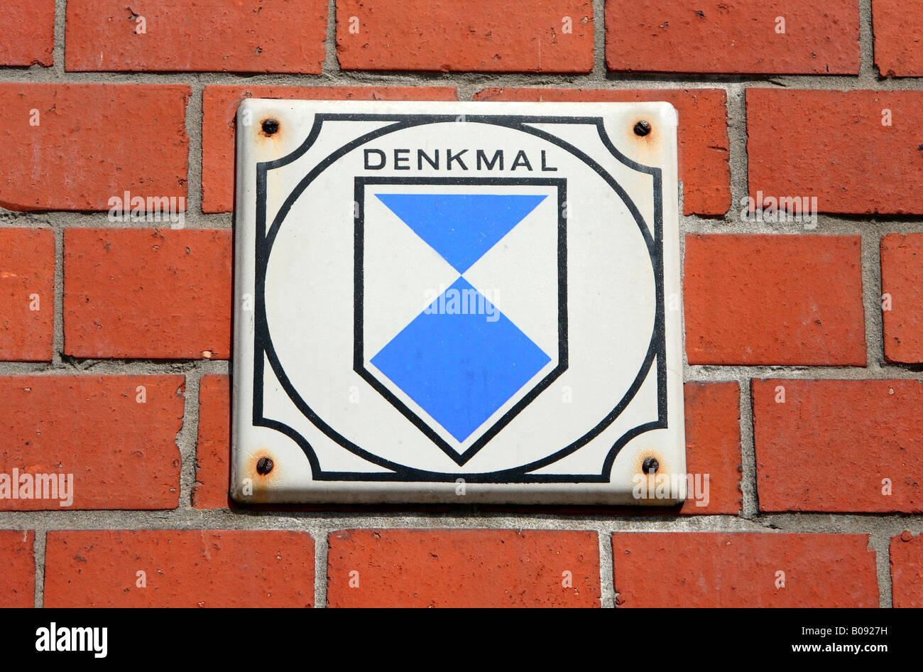 Plaque mounted on a brick wall marking an historic building, Germany ...