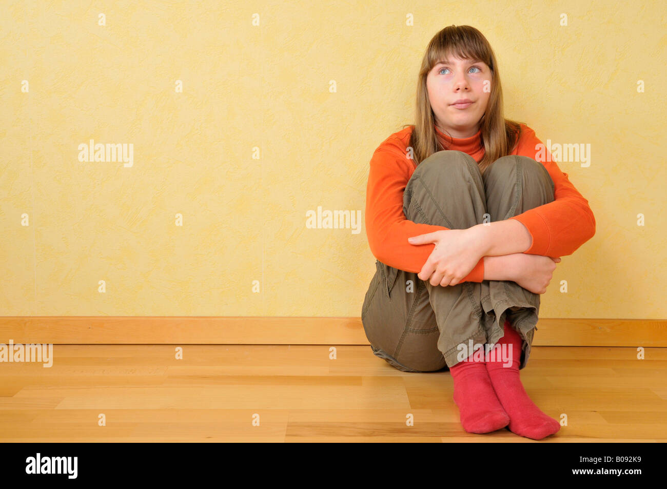 Girl sitting in her room, bored Stock Photo - Alamy