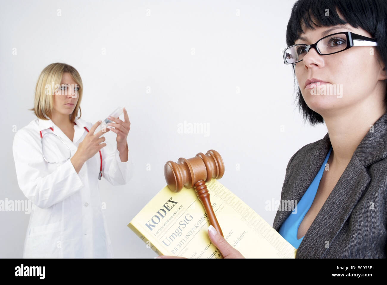 woman doctor contra woman judge Stock Photo - Alamy
