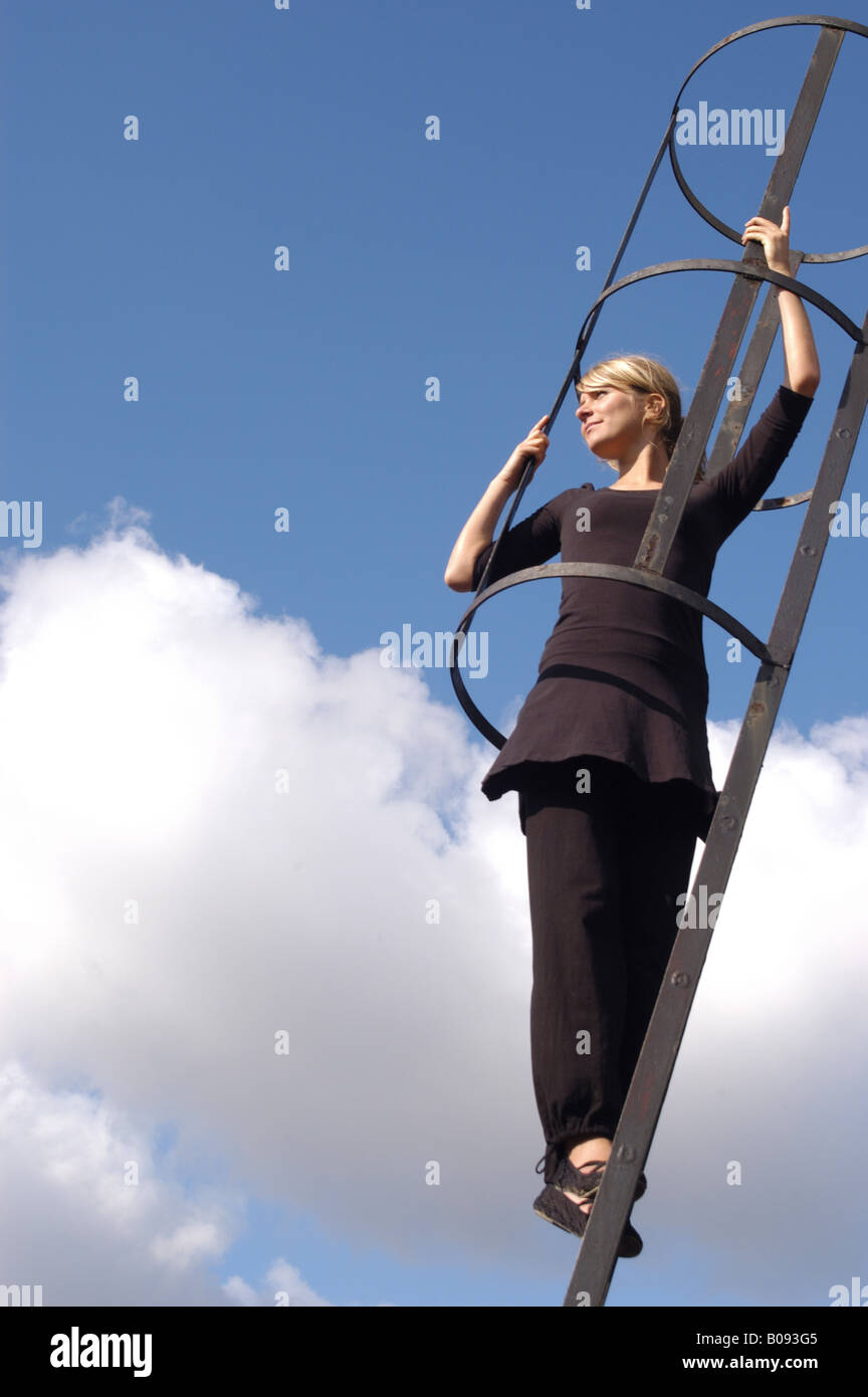 Women climbing ladders hi-res stock photography and images - Alamy