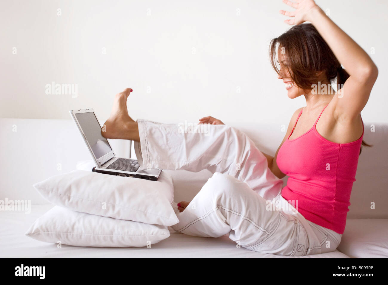 Woman kicking her laptop Stock Photo - Alamy
