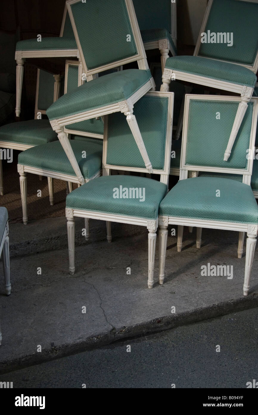 Chairs stacked haphazardly on top of one another Stock Photo - Alamy