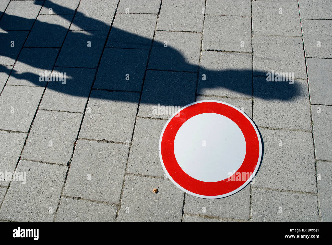 Pedestrian's shadow and traffic sign: no entry on a sidewalk, footpath ...