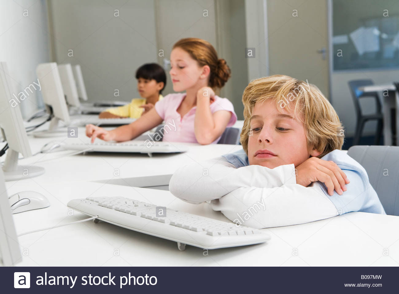 Boy Sitting At Computer Typing Stock Photos & Boy Sitting At Computer ...