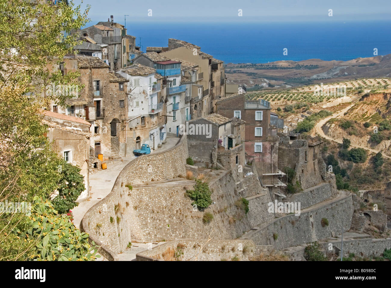 Mountain village built on very steep terraces, view of orchards and sea ...