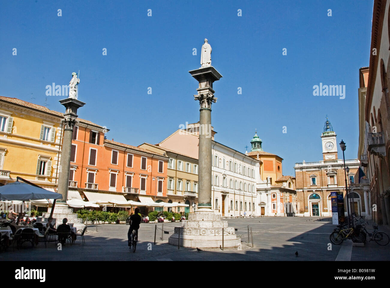 Two statues on top of columns in the Piazza del Popolo town square ...
