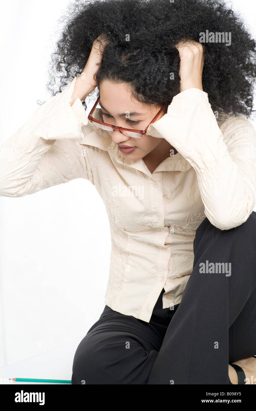 Portrait of woman pulling on hair Stock Photo - Alamy