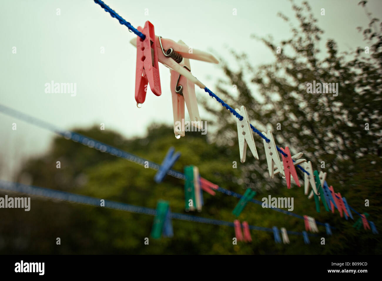 Pegs on a clothes line after heavy rain fall Stock Photo - Alamy