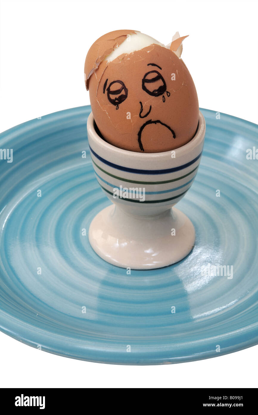 A sad and unhappy hard boiled egg with its top smashed off Stock Photo ...