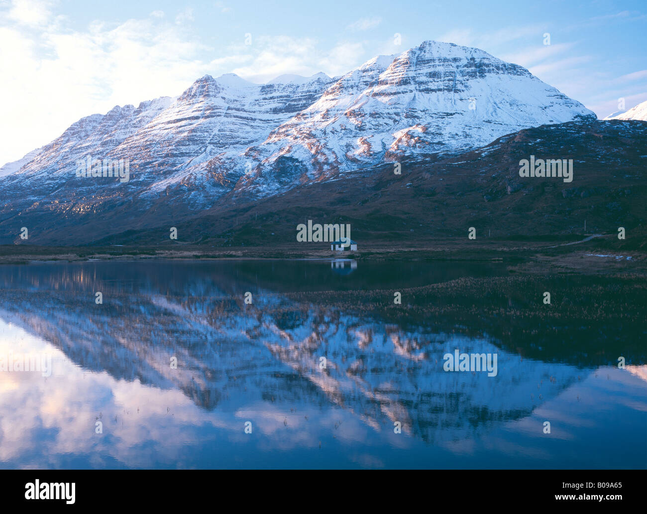 Liathach in snow reflected in small loch Glen Torridon Wester Ross ...