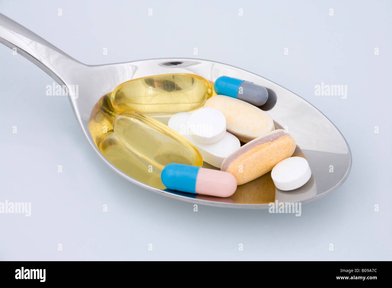 various medical pills and capsules on a spoon Stock Photo - Alamy