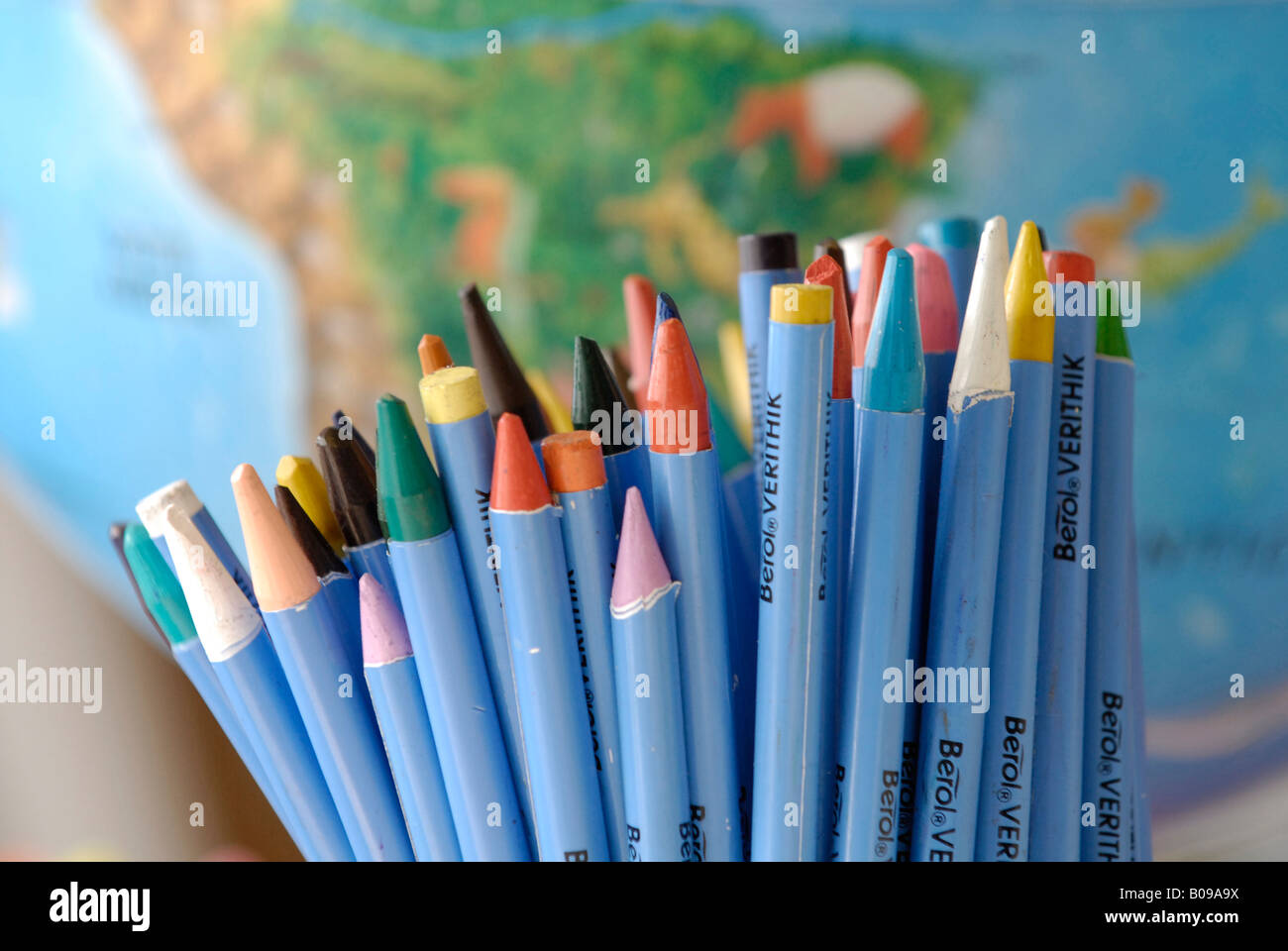 Close-up of crayons in classroom in front of a world globe Stock Photo ...