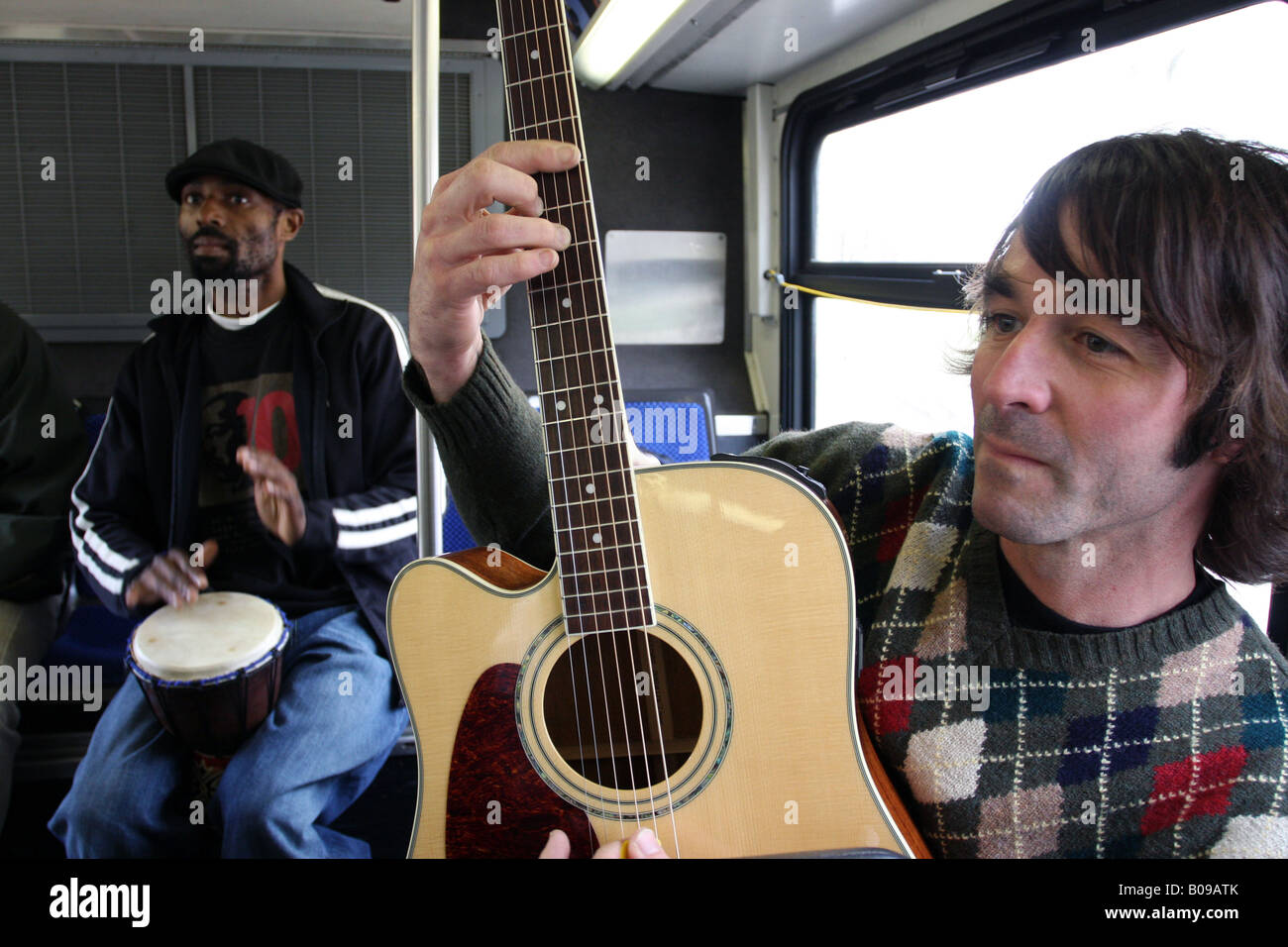Two performers play music on a public city bus in New Haven Connecticut ...