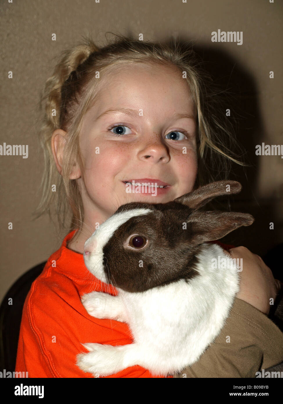 A young girl holding her pet rabbit at a rabbit and poultry show in the ...