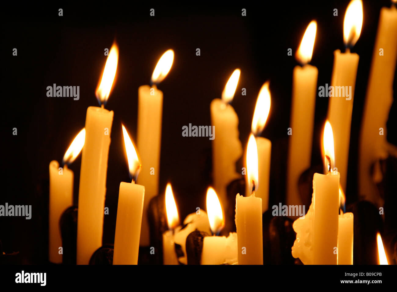 many lit candles in dark room in church Stock Photo - Alamy