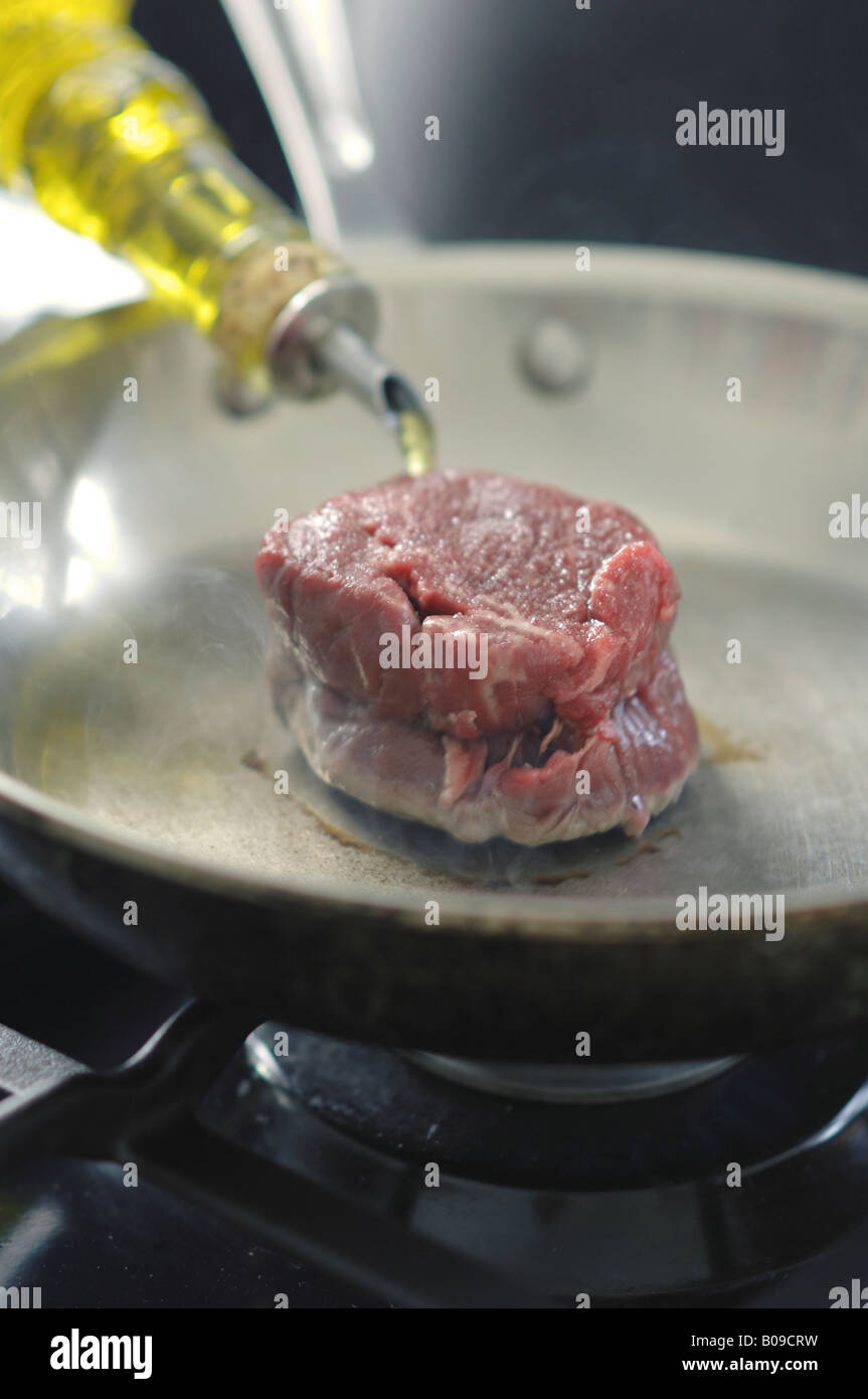 Raw steak being grilled Stock Photo - Alamy
