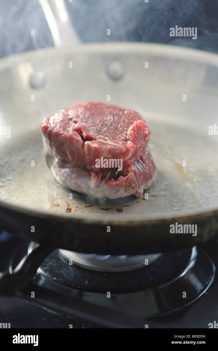 Raw meat being cooked Stock Photo - Alamy