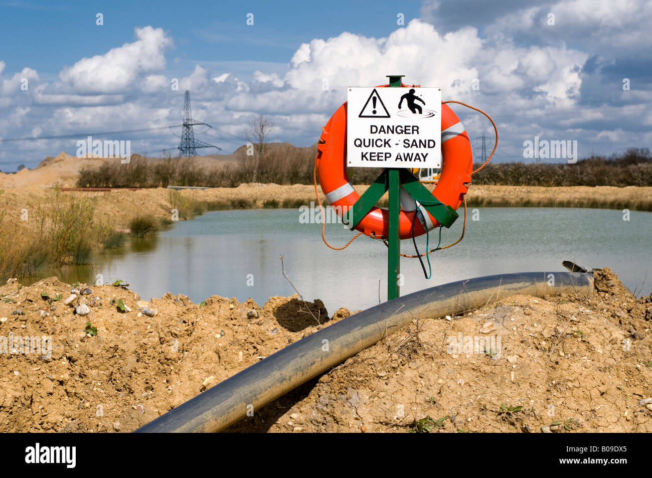 Danger sign at sand and gravel excavation site Stock Photo - Alamy