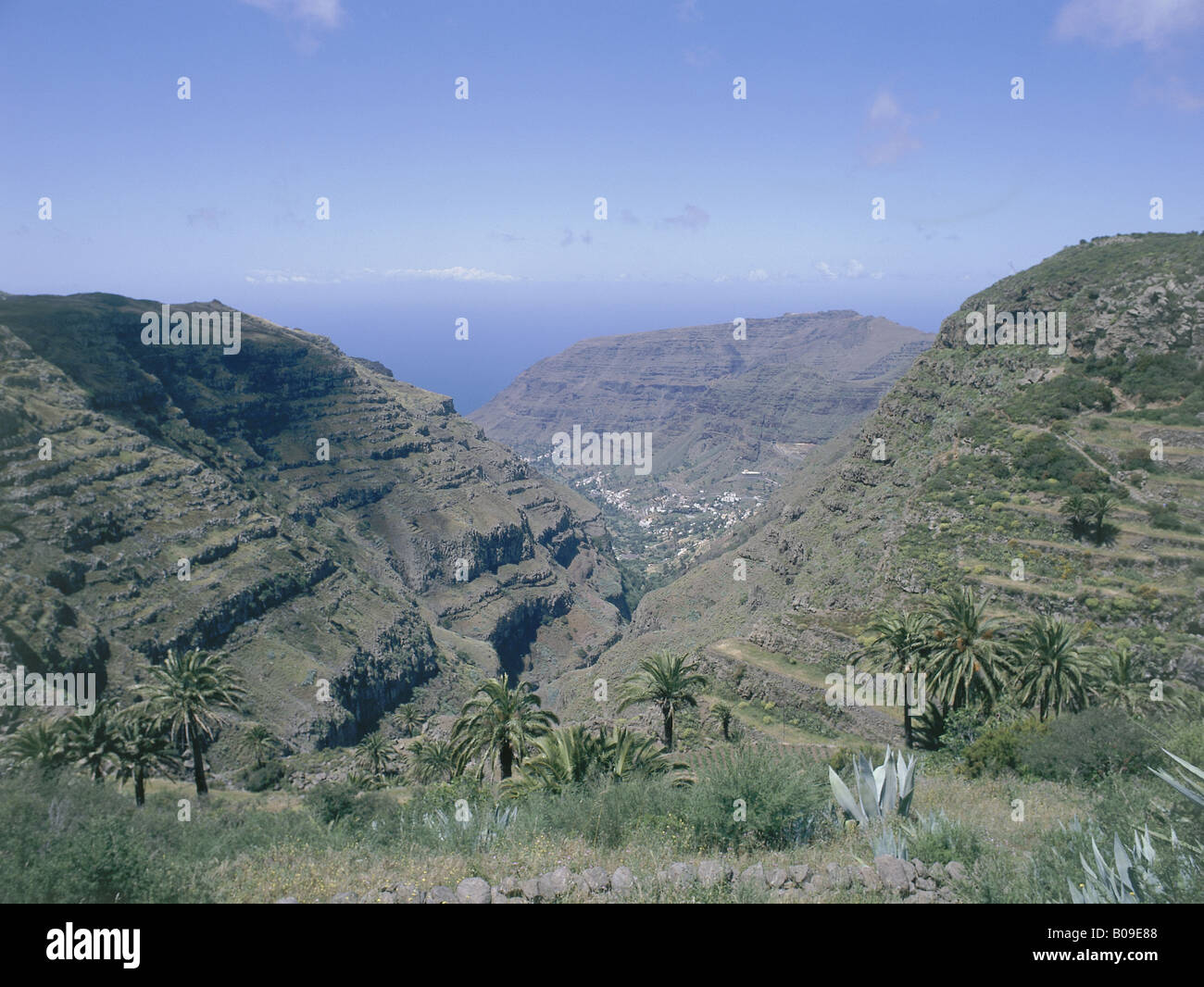 Deep valley in hills Terraced sides View of village White houses Sea ...