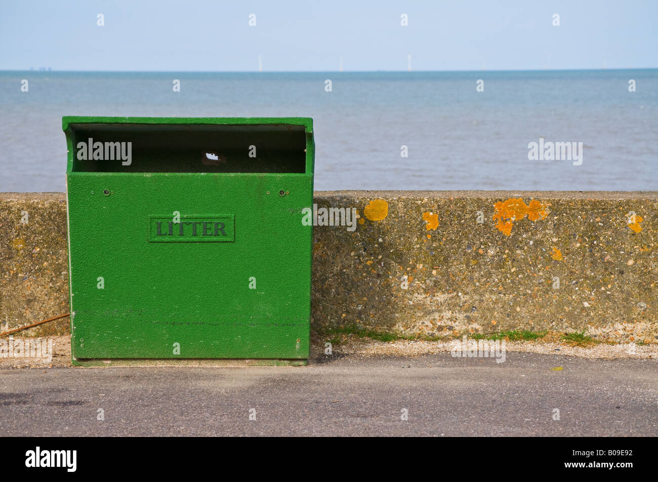 Damaged / vandalized Green litter bin at the seaside Stock Photo - Alamy